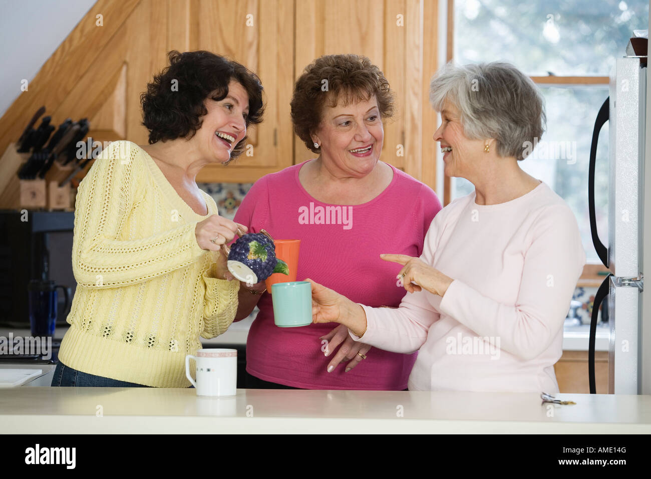 Three women in a conversation at a tea party Stock Photo - Alamy