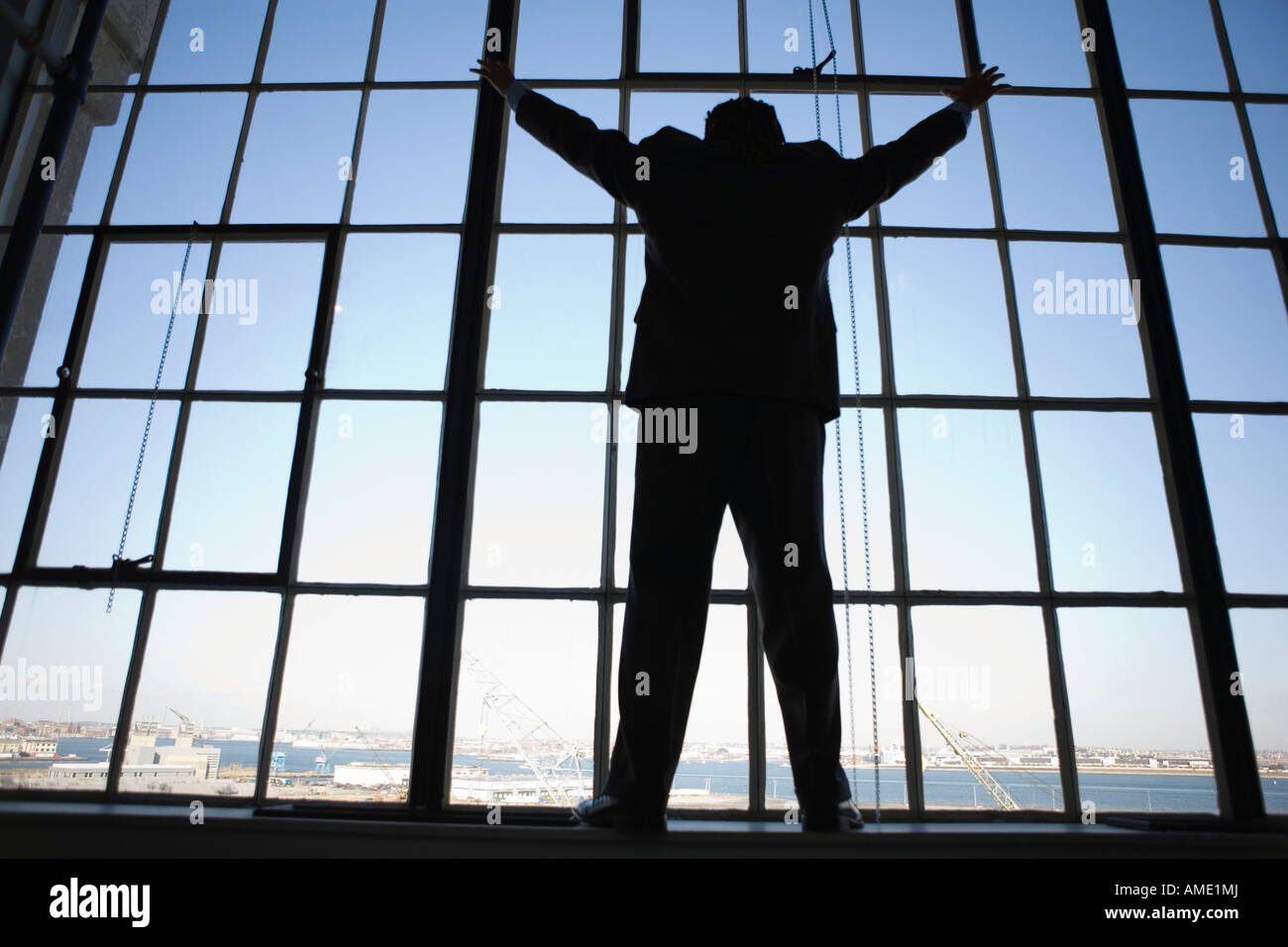 A young man looking out of window glass Stock Photo - Alamy
