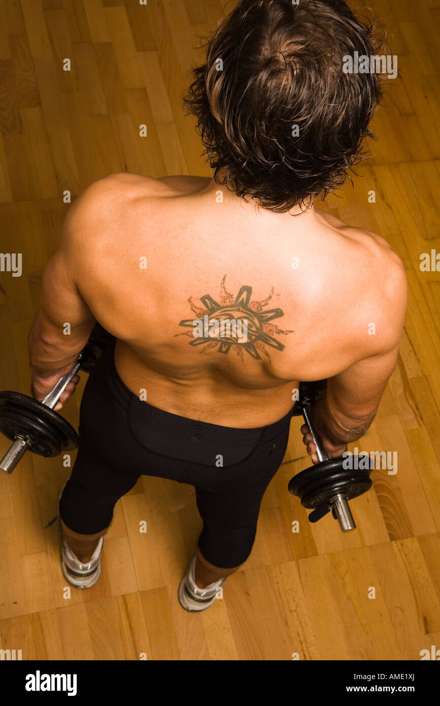 tattoed back of man weight training Stock Photo - Alamy