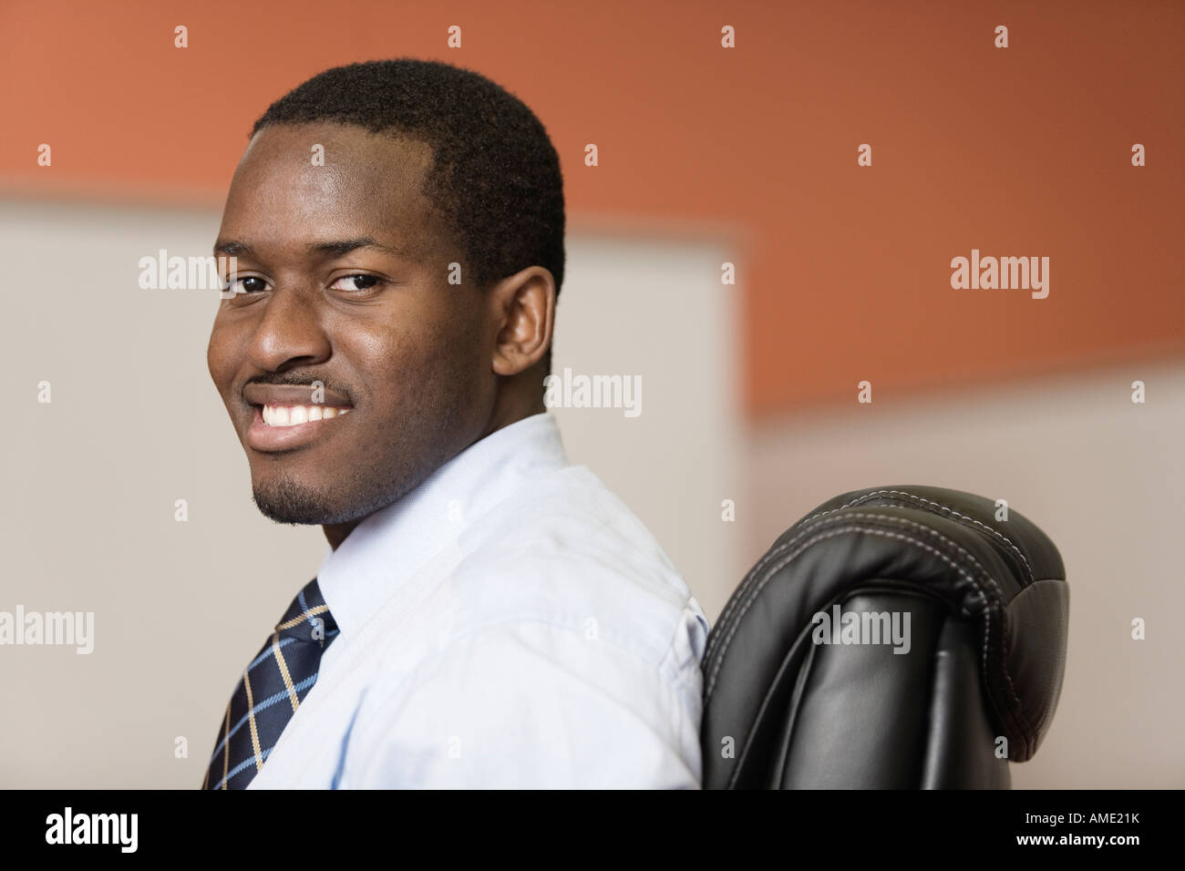 A Business man smiling in office Stock Photo - Alamy