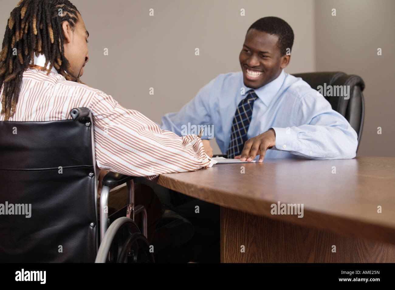 Two businessmen talking in an office Stock Photo - Alamy