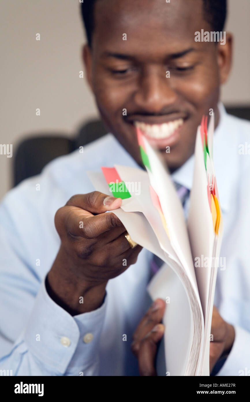 A Business man looking at a file Stock Photo - Alamy