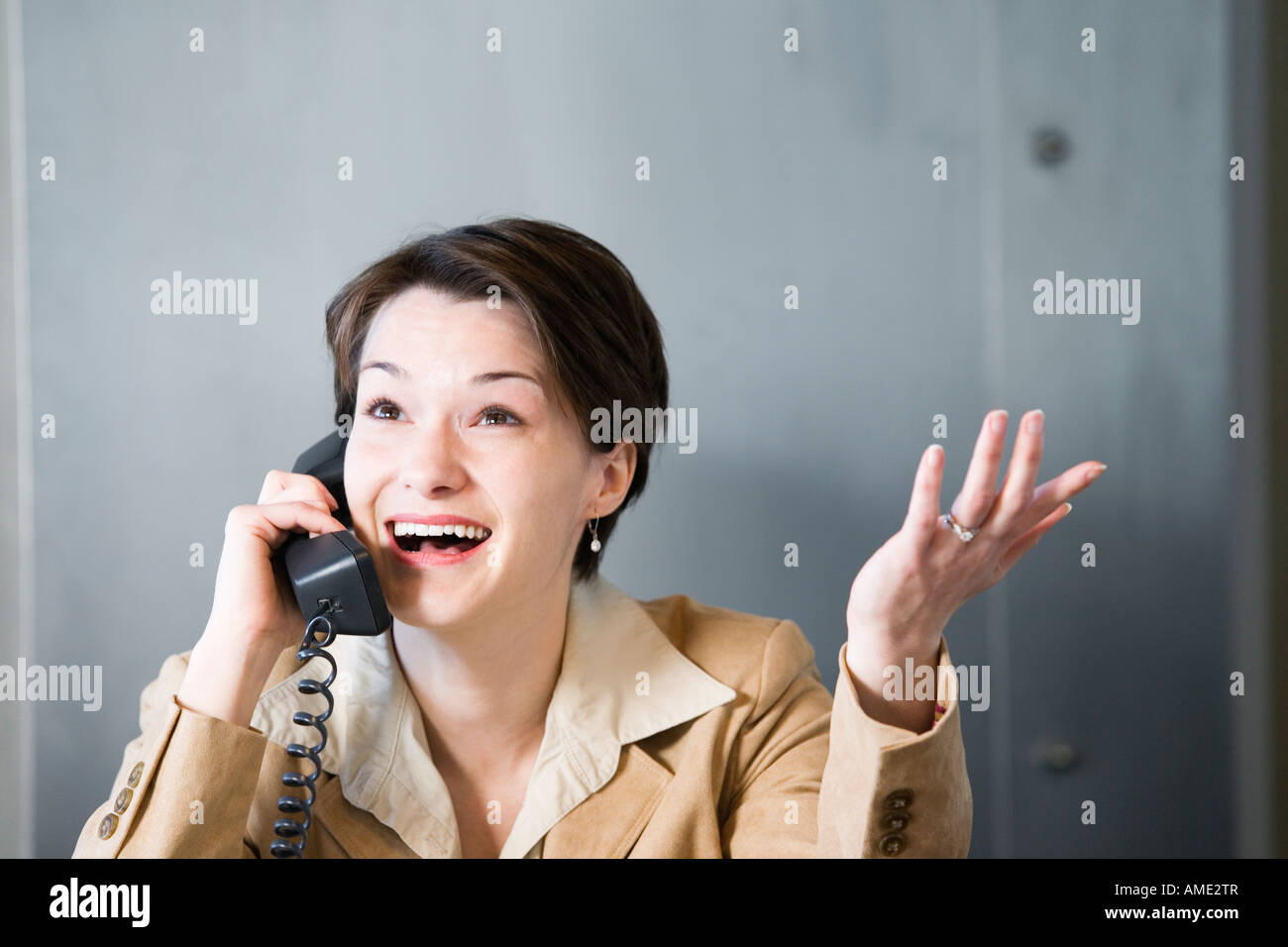 Business woman conversing over telephone Stock Photo - Alamy