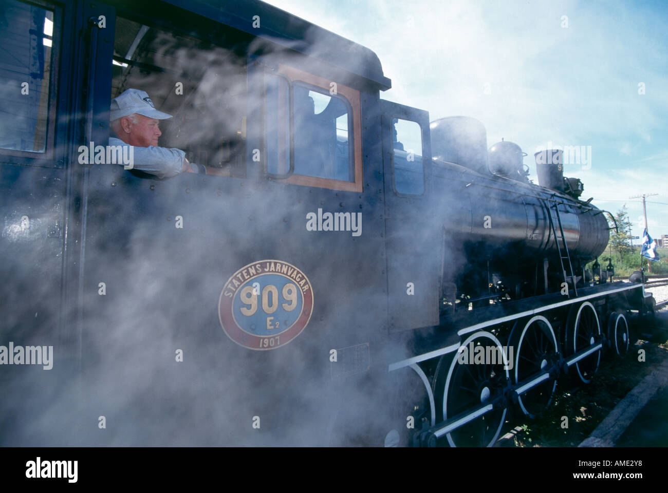 Driver looking out of the window on the engine of a steam train in ...