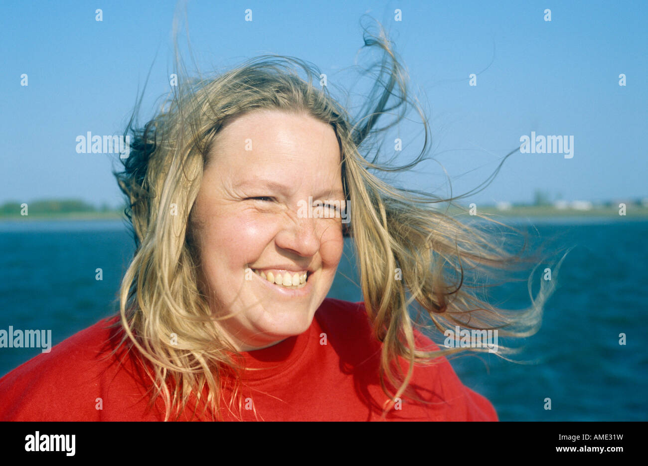 portrait of a young woman with her hair flying in the wind Stock Photo ...