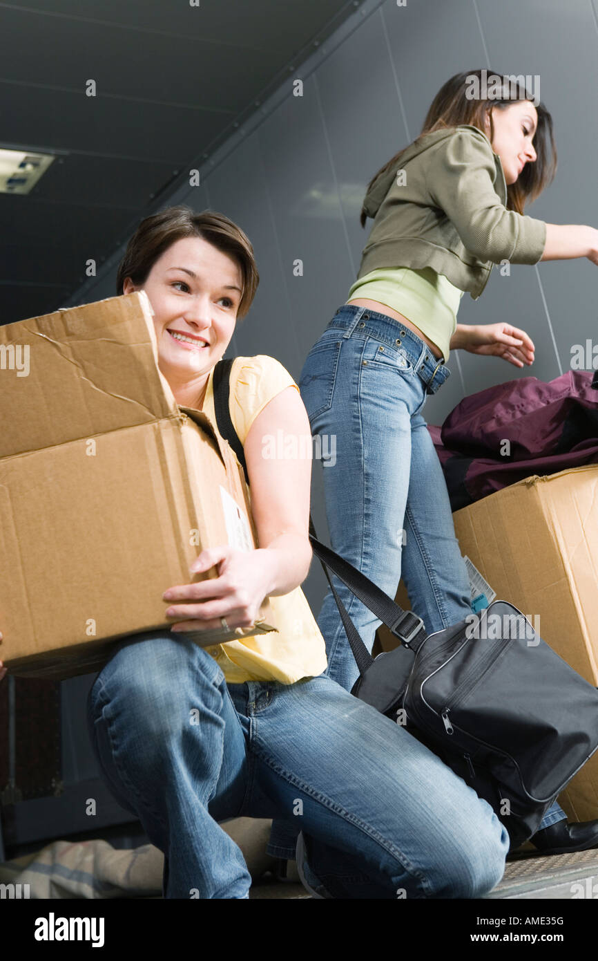 Women packing her belongings in cardboard box Stock Photo - Alamy