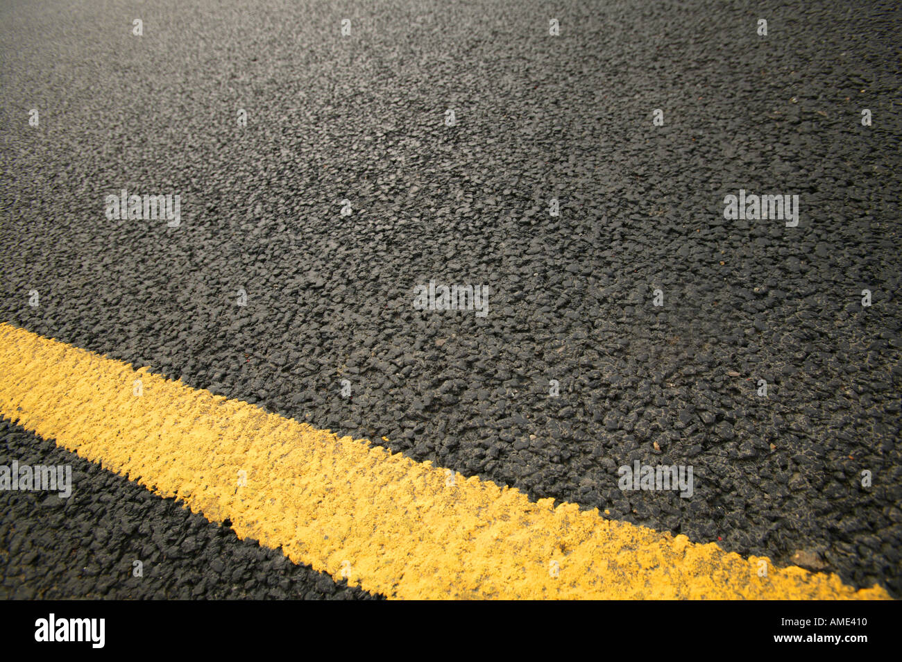 tarmac and a yellow line on a road Stock Photo - Alamy