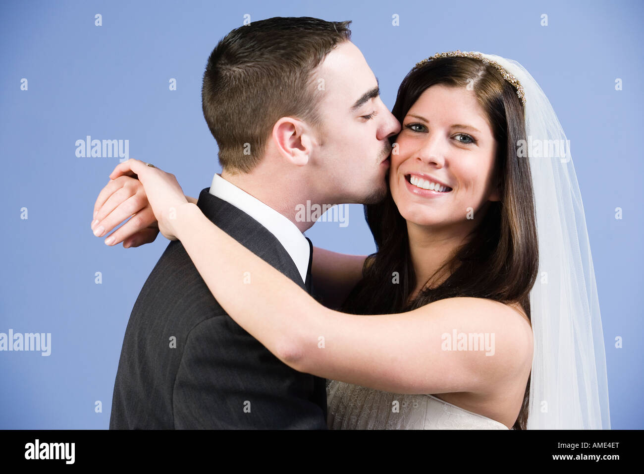 Side view of a groom kissing her bride Stock Photo - Alamy