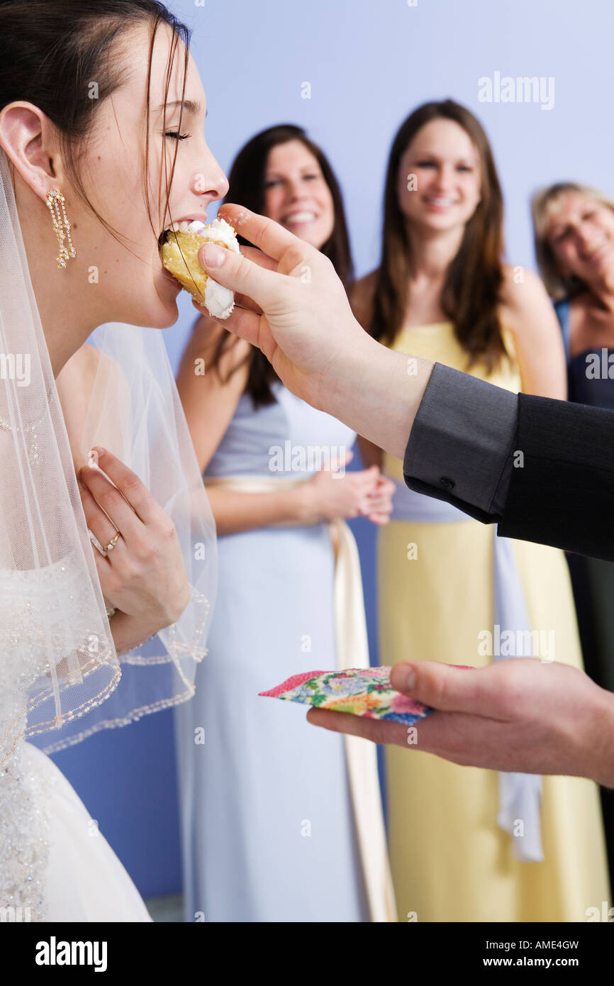 Side view of a bride eating cake Stock Photo - Alamy
