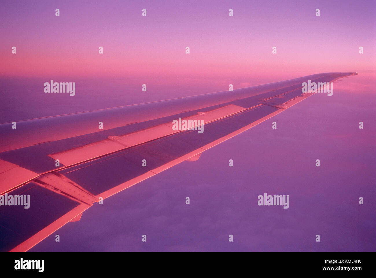 Airplane Wing at Sunset Stock Photo - Alamy