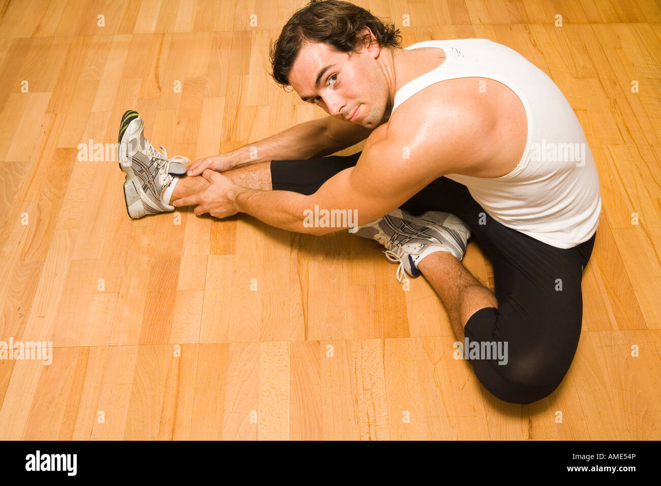 man stretching looking at camera Stock Photo - Alamy