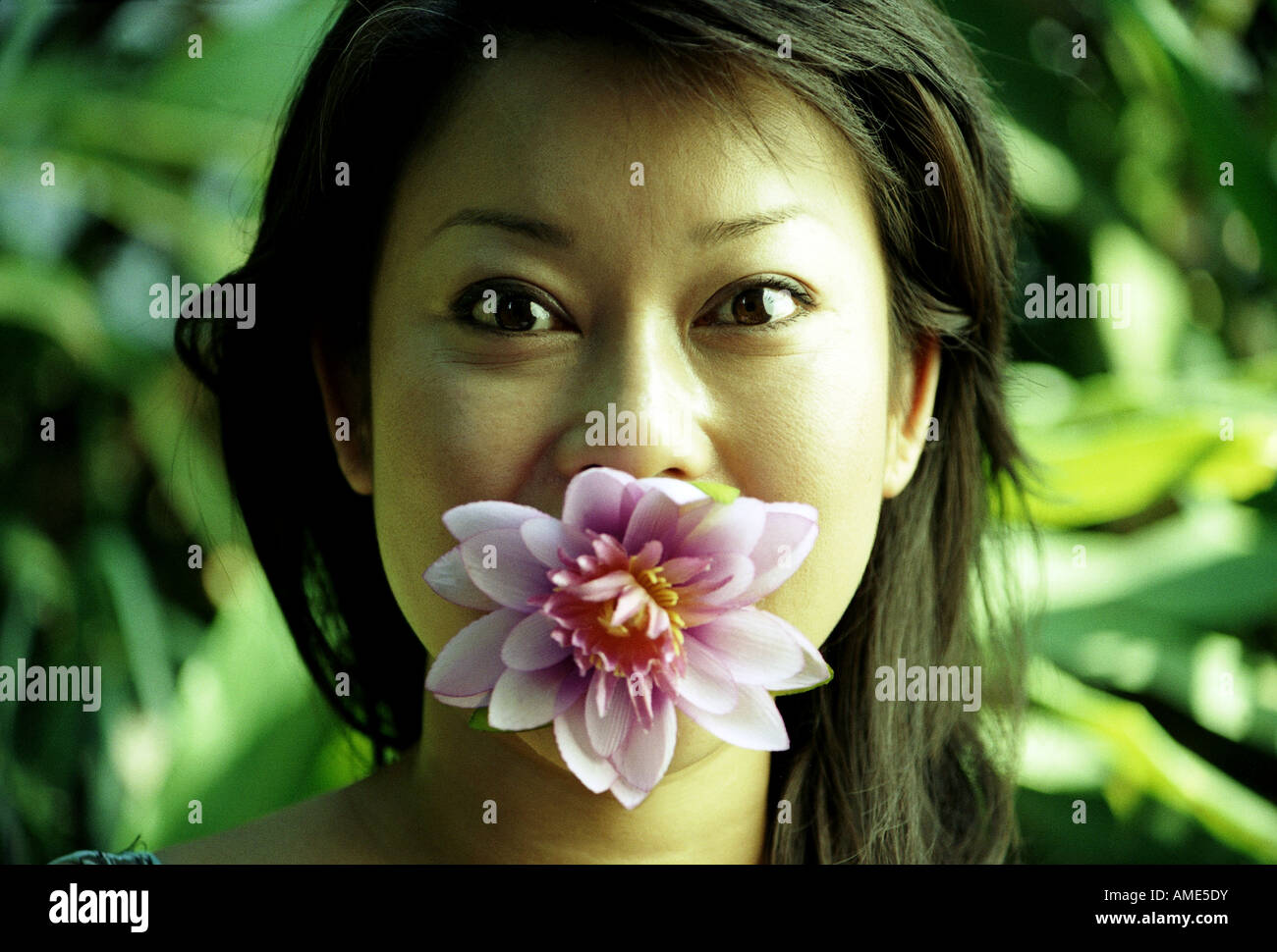 Woman with Flower in Mouth Stock Photo - Alamy