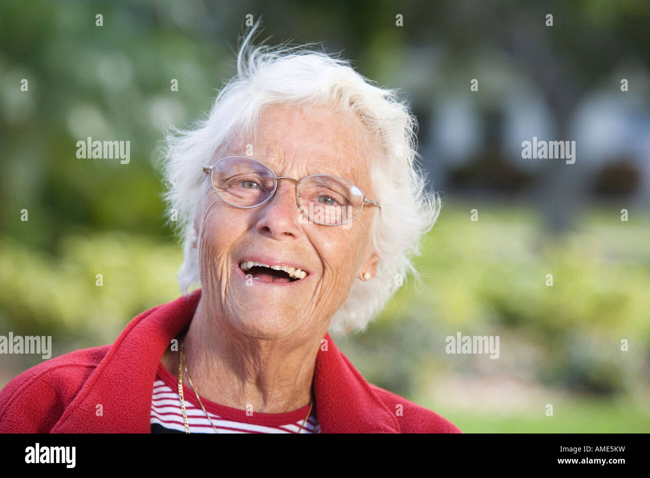Portrait of a senior woman smiling Stock Photo - Alamy