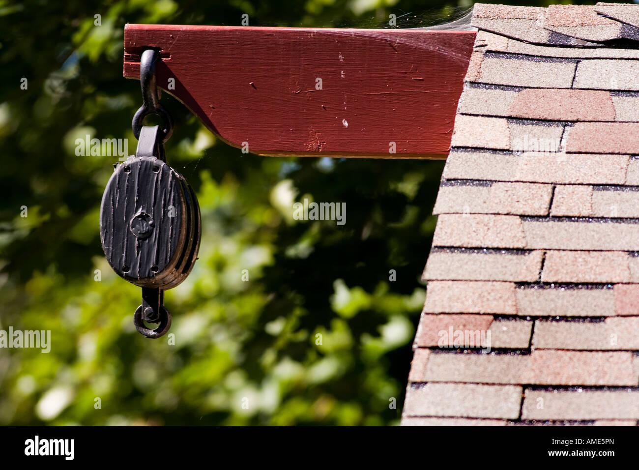 Block attached to a fixed position on the overhang of a roof ridge ...