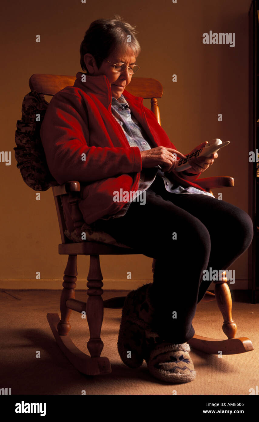 Woman sitting on a chair making a phone call Stock Photo - Alamy