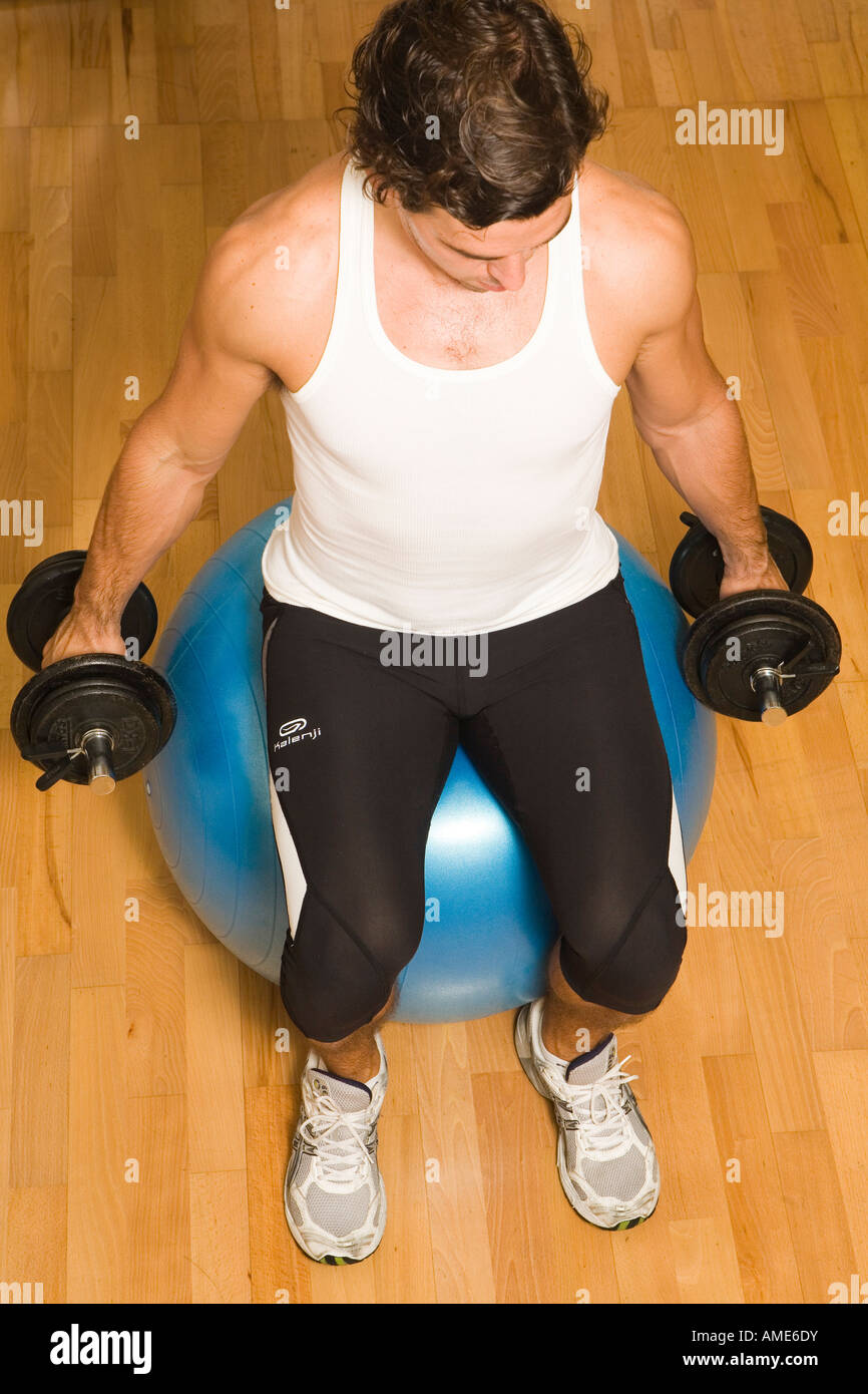 man weight training on ball Stock Photo - Alamy