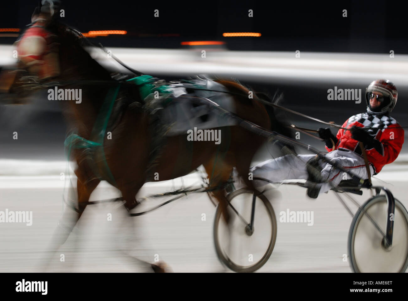 Close up blur of Harness Racing Pacer and Jockey at night Stock Photo ...