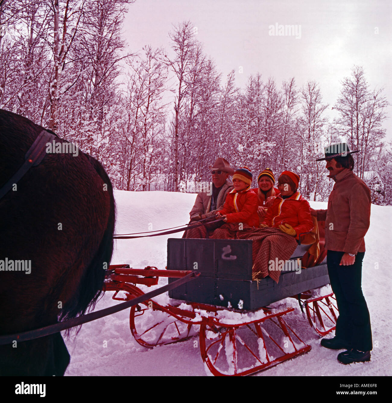 Sleigh riding in a wintry scene A family outing in the snow Stock Photo ...