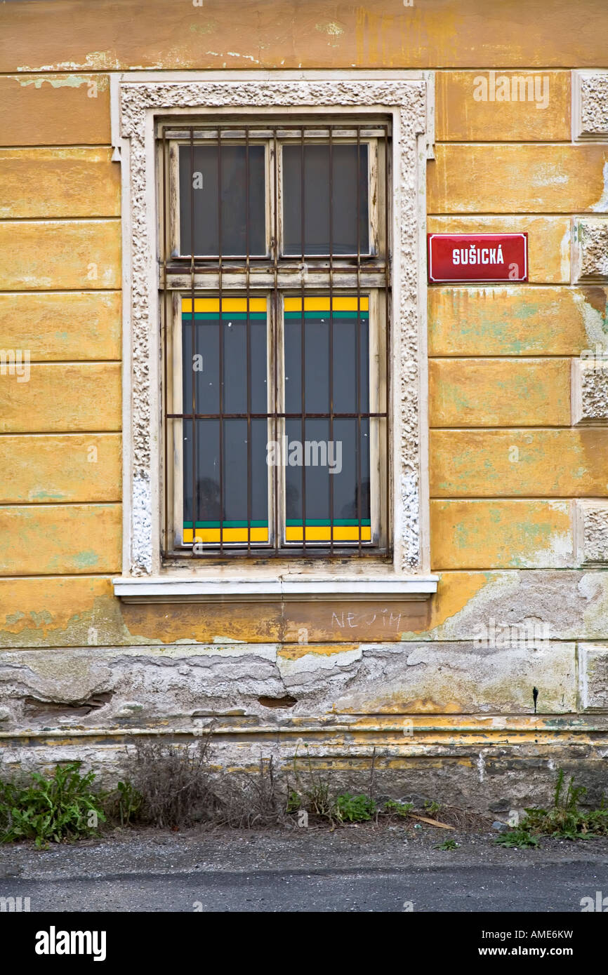 Window and street sign with faded paint and poor state of building ...