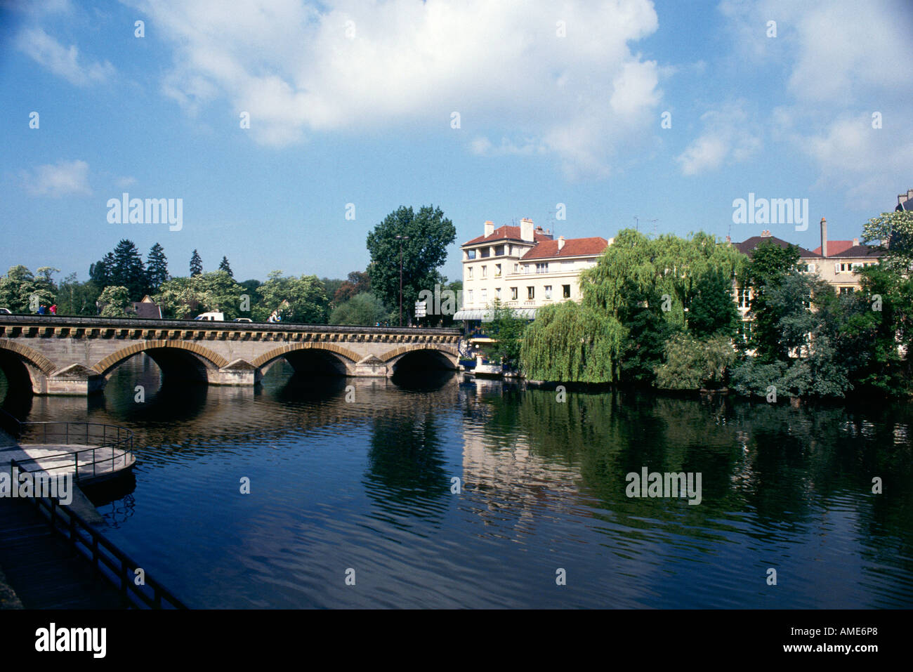 Willows dip their trailing branches into the gently flowing river ...