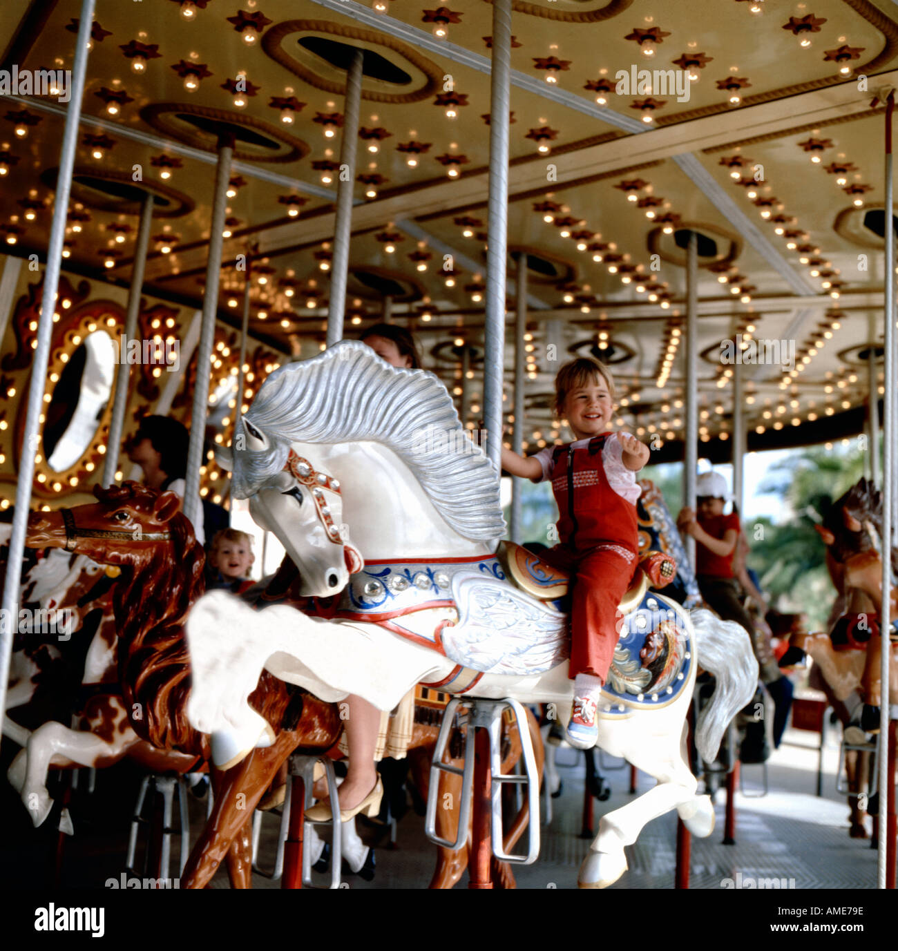 Girl riding on merry go round hi-res stock photography and images - Alamy