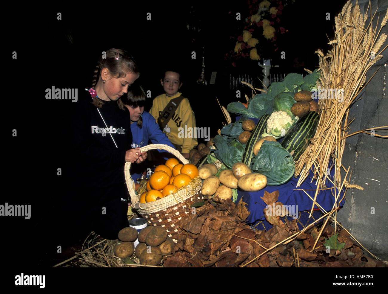 Harvest Festival with children bringing foods to a church Stock Photo ...