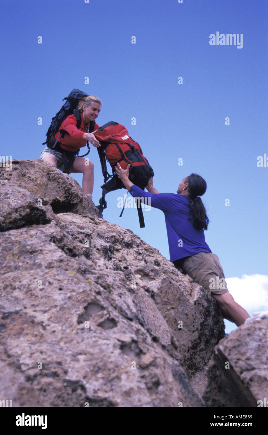Man Handing Woman a Backpack Stock Photo - Alamy
