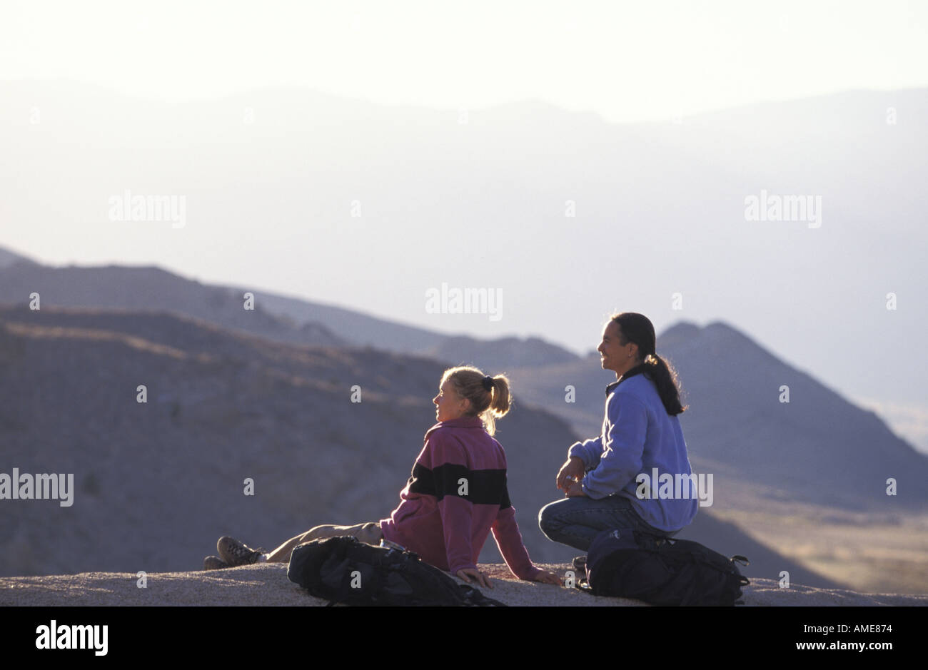 Man and Woman Sitting on Rock Together Stock Photo - Alamy