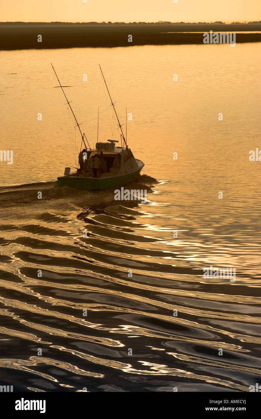 A Fishing Boat Leaving Wakes in its Path Stock Photo - Alamy