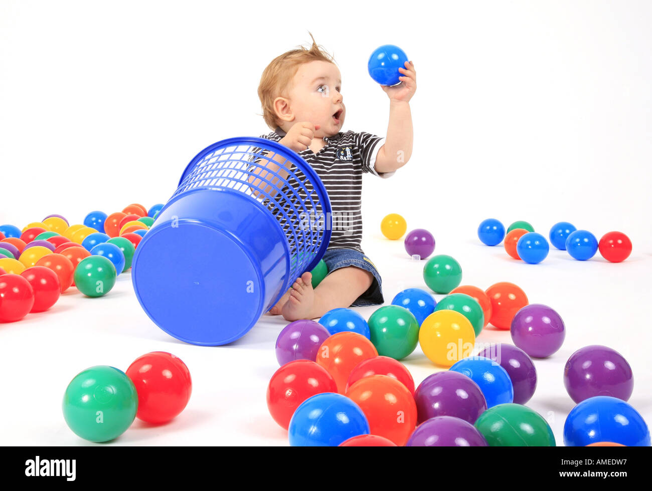 Small boy playing with coloured balls hi-res stock photography and ...