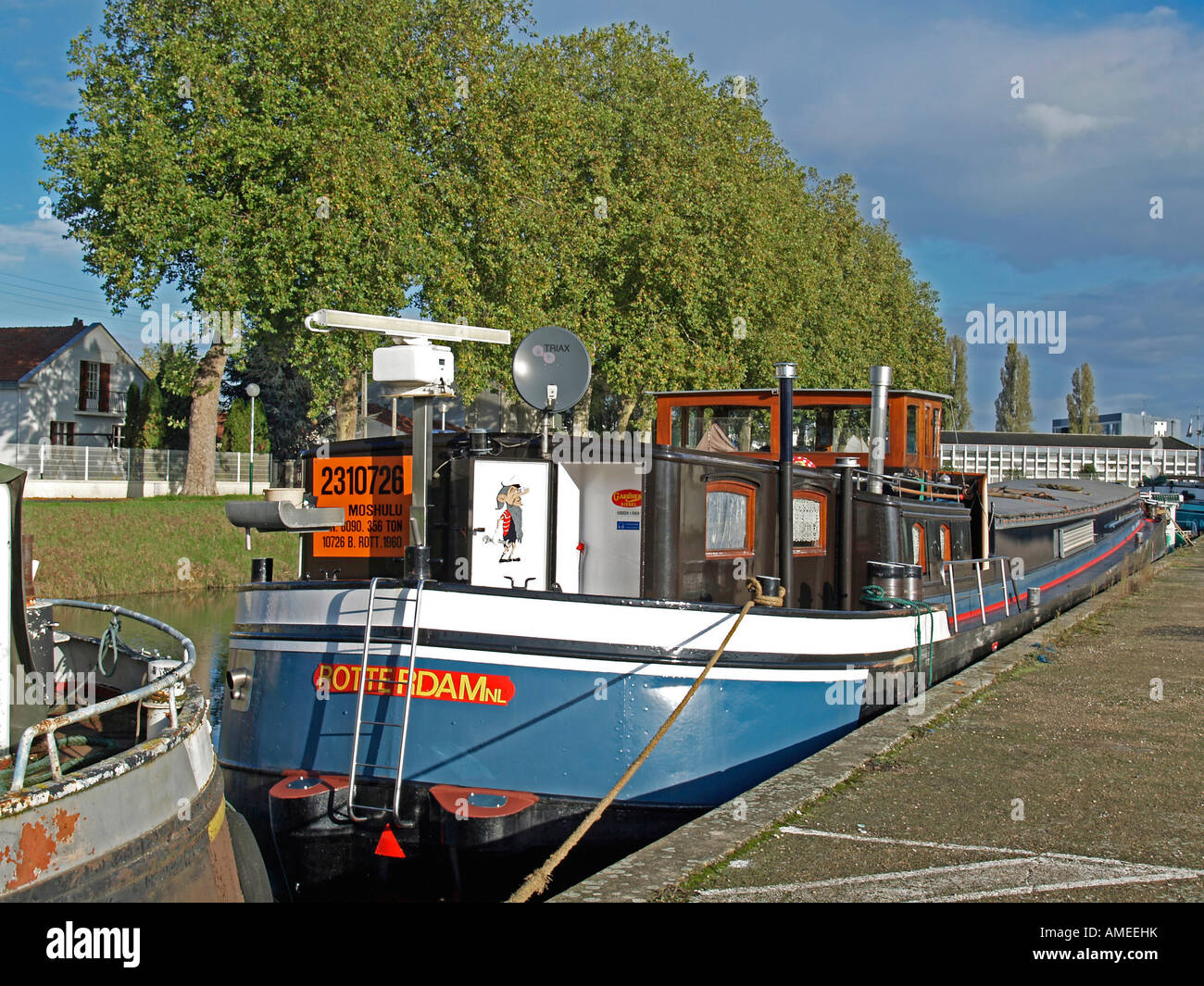 ships barges anchoring at a channel of a river at Canal de la Marne in ...