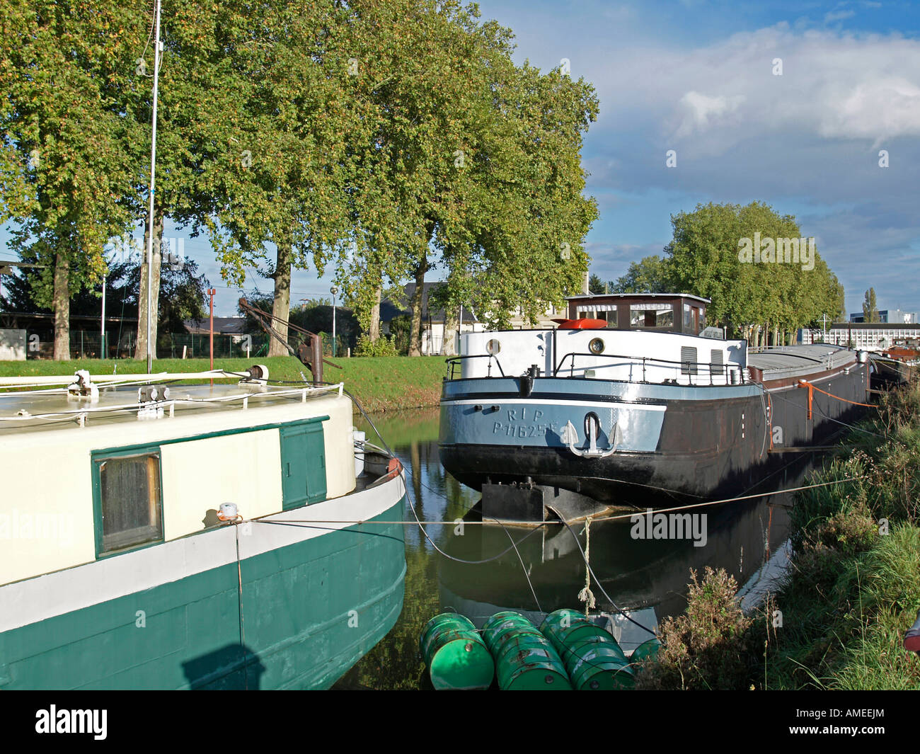 ships barges anchoring at a channel of a river at Canal de la Marne in ...