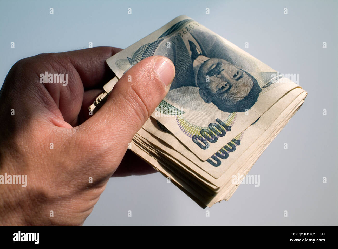 Close-up of a hand holding Yen bank notes (japanese currency Stock ...