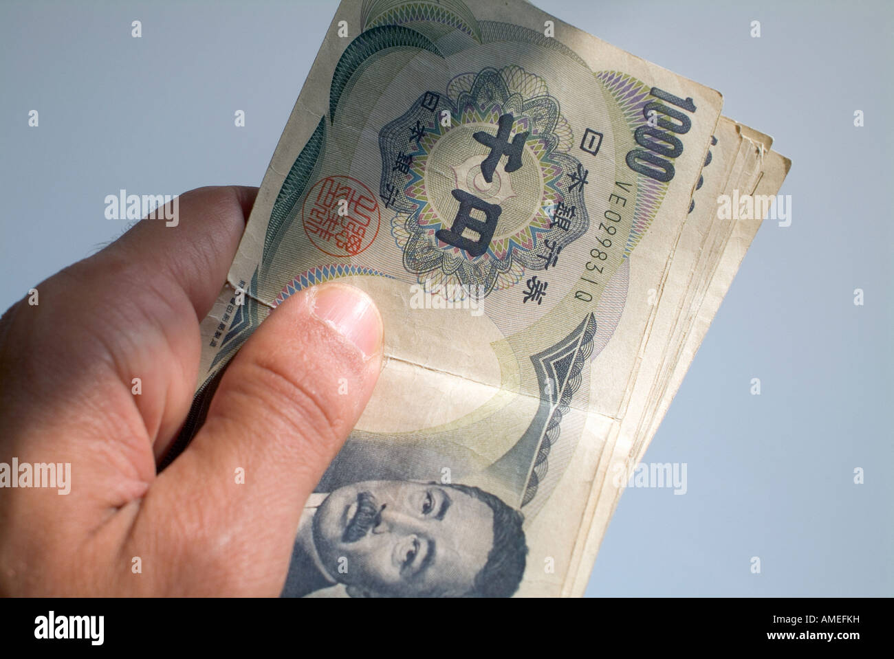 Yen notes and hand hi-res stock photography and images - Alamy