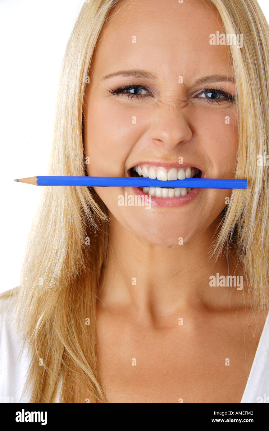 young, blond woman with pencil between her teeth Stock Photo - Alamy