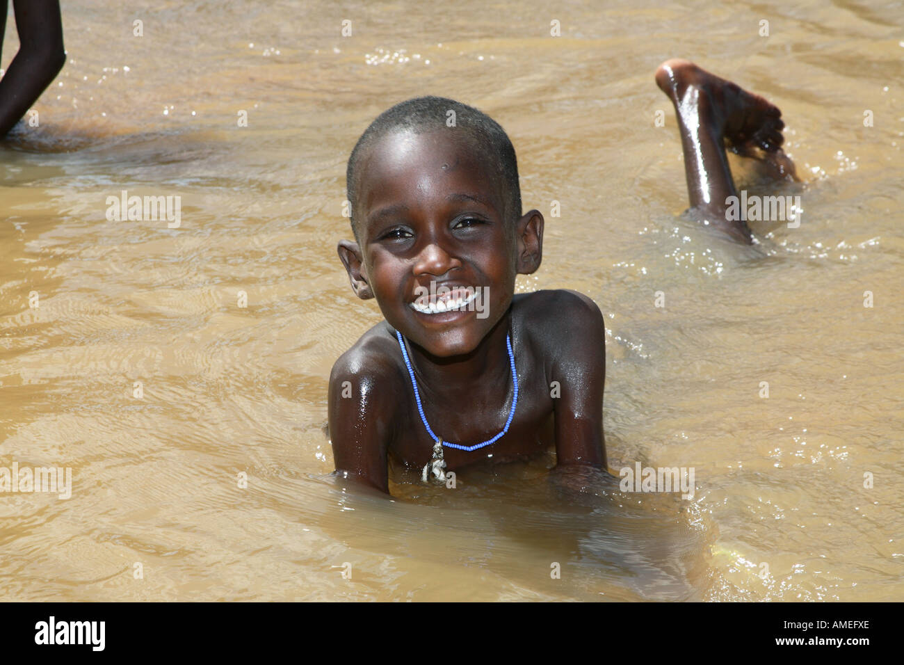 Samburu boy bathing in Uaso Nyiro river, Kenya, Samburu Np Stock Photo ...