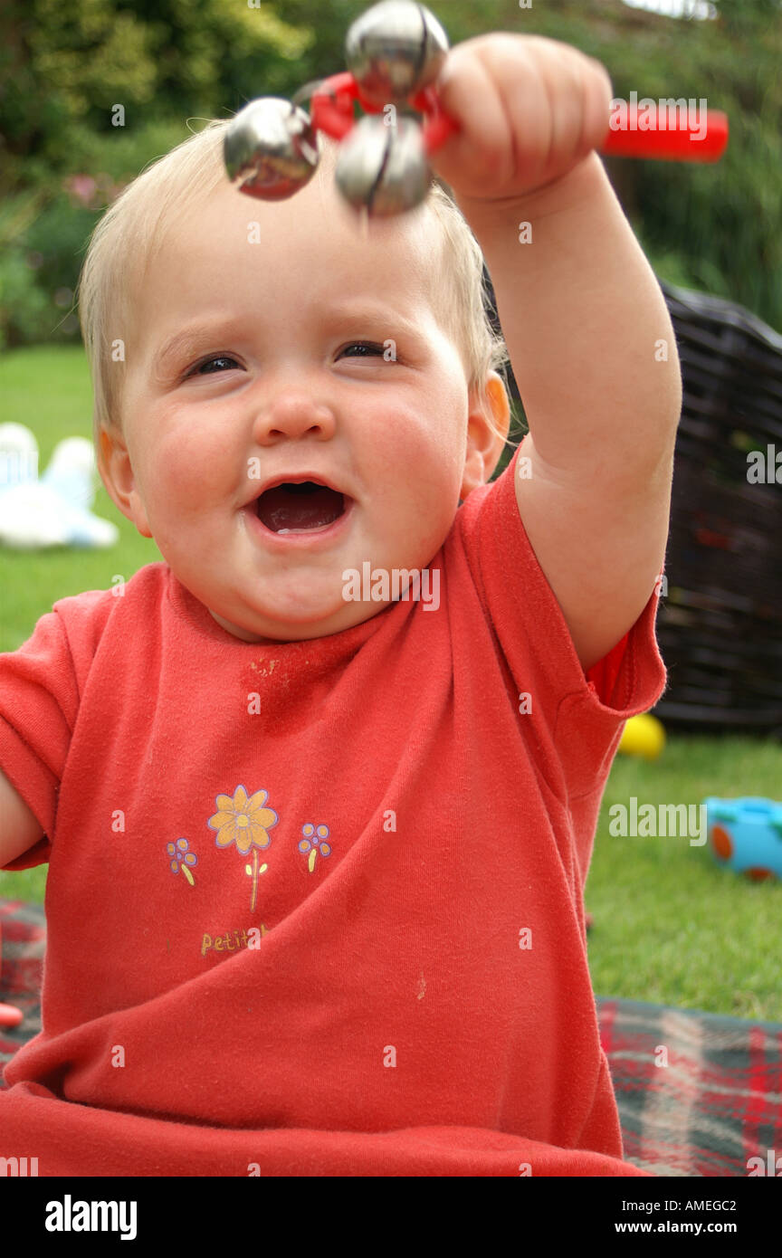 Baby Girl holding toy Stock Photo - Alamy