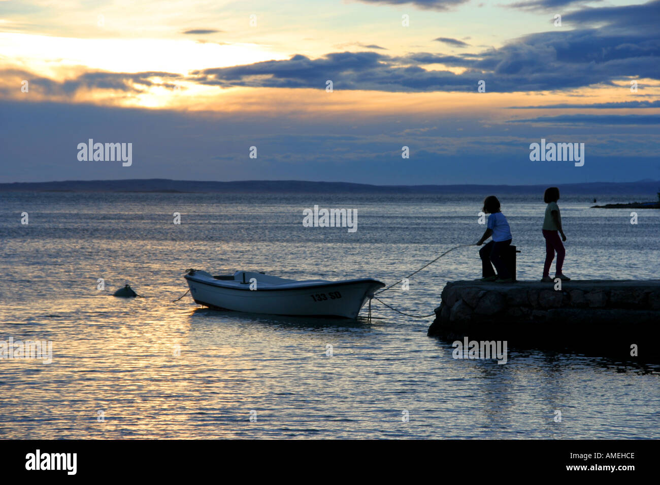 A girl playing with boat in Starigrad Paklenica port Stock Photo - Alamy