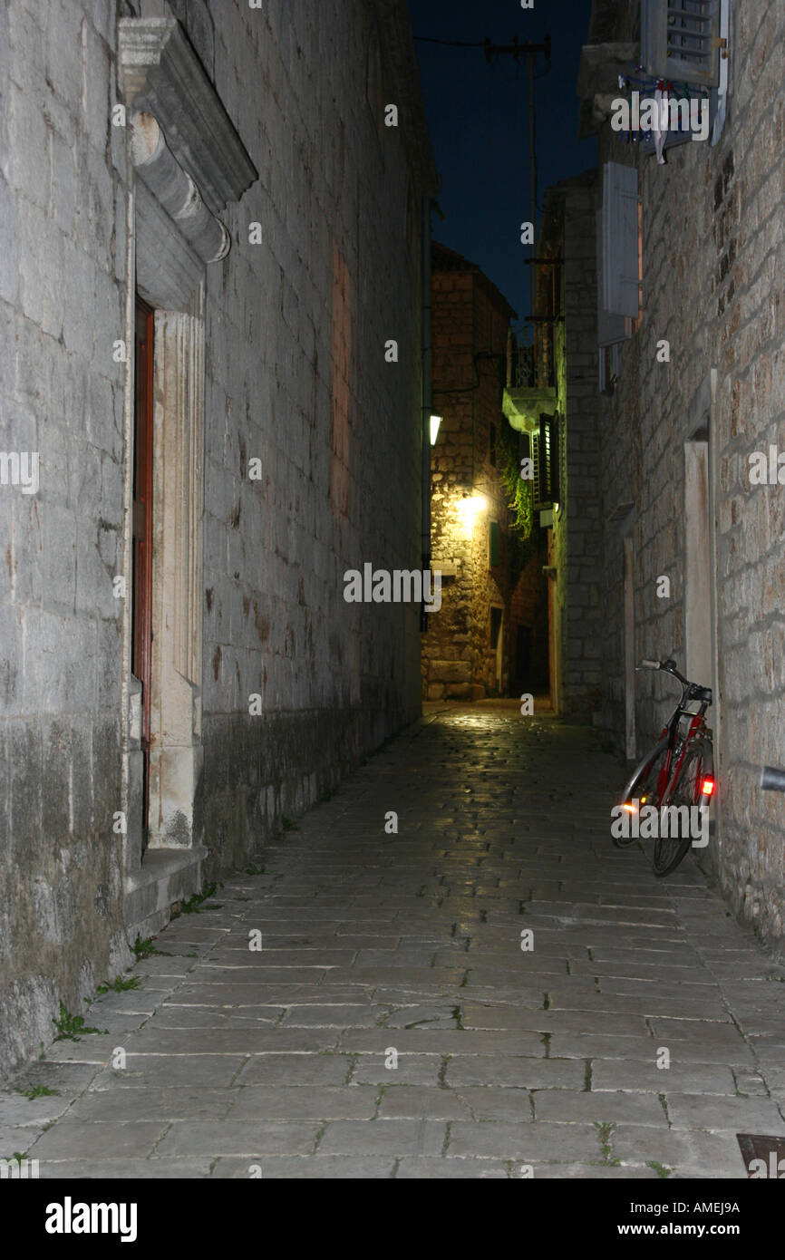 A narrow street in Stari Grad town at night on Hvar Island Stock Photo ...