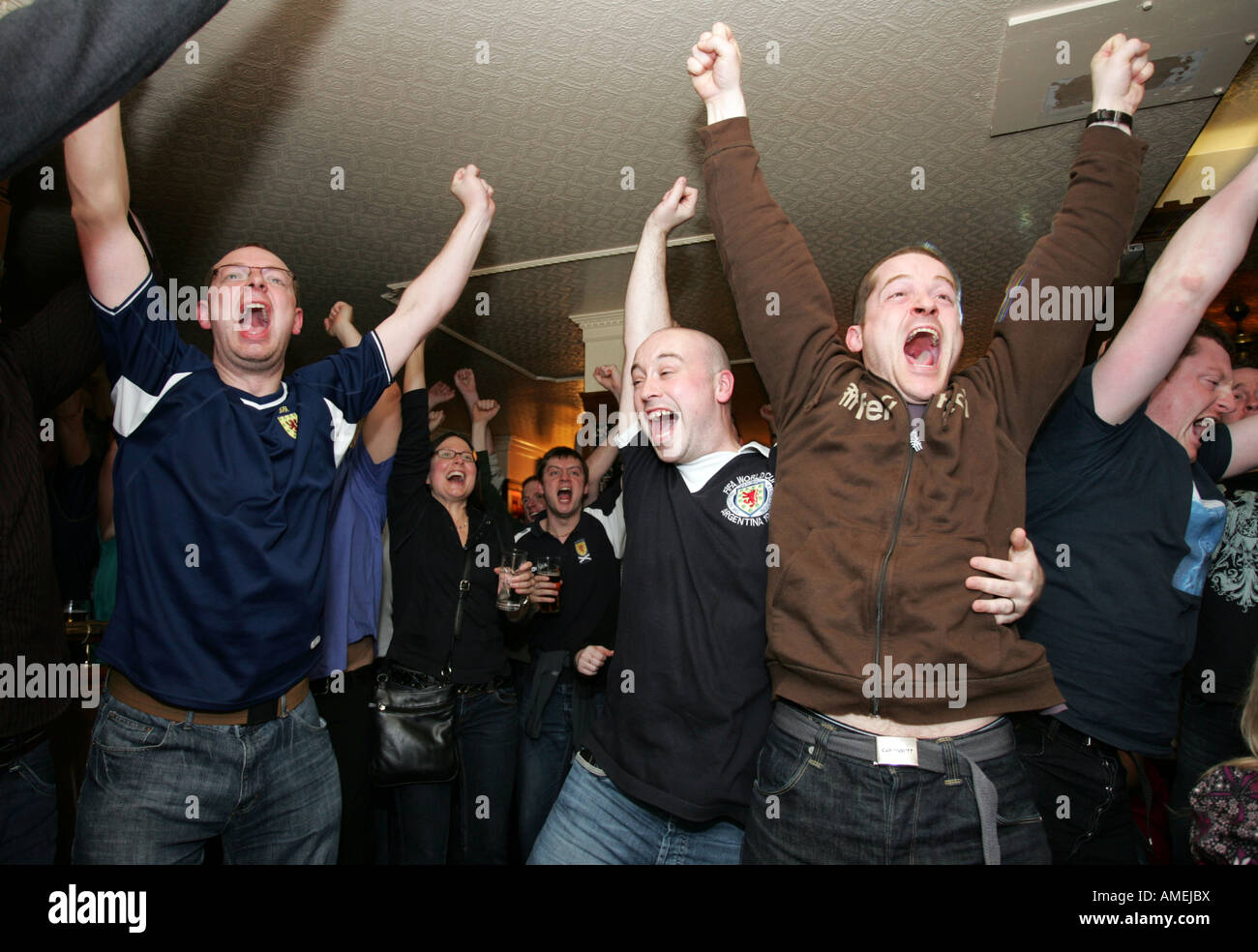 Scottish football fans cheering with emotion as they watch their team ...