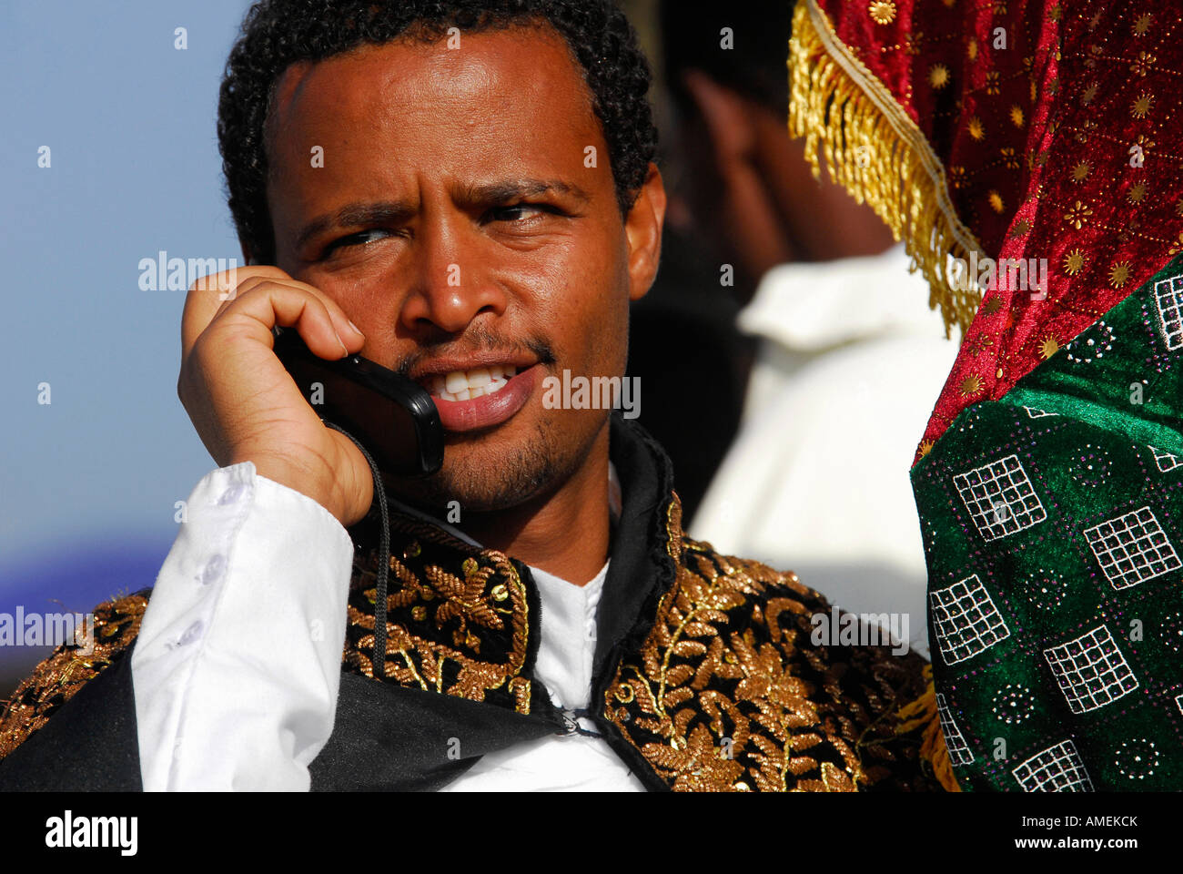 A handsome Ethiopia male speaking on a cellphone during a religious ...