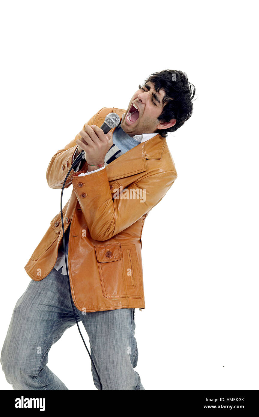 Young Man Singing into Microphone Stock Photo - Alamy