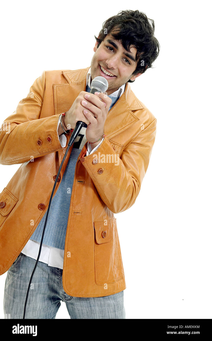 Young Man Singing into Microphone Stock Photo - Alamy