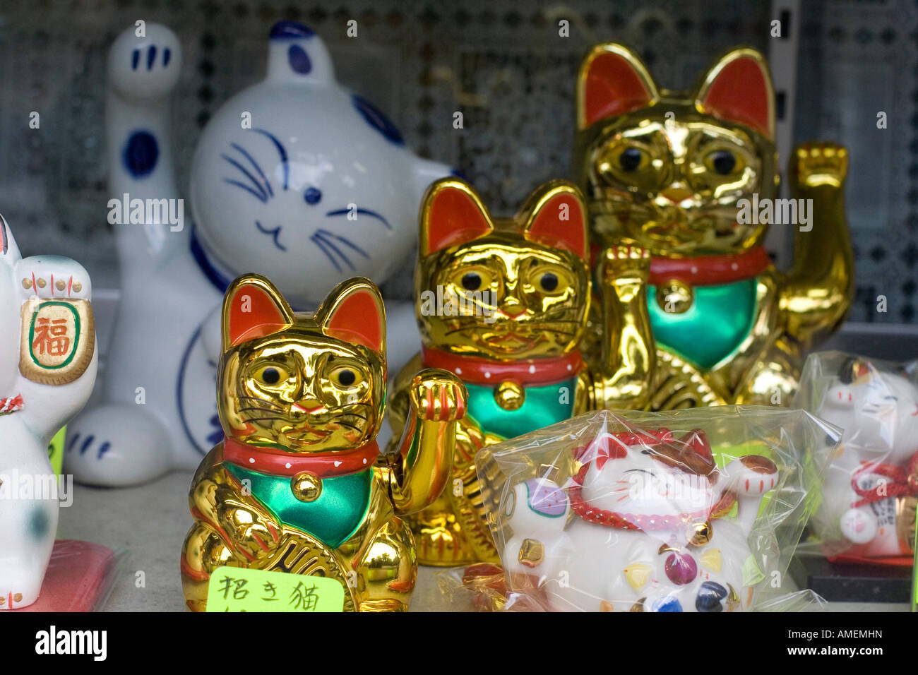 Maneki Golden Japanese Lucky cats in a window display Stock Photo - Alamy