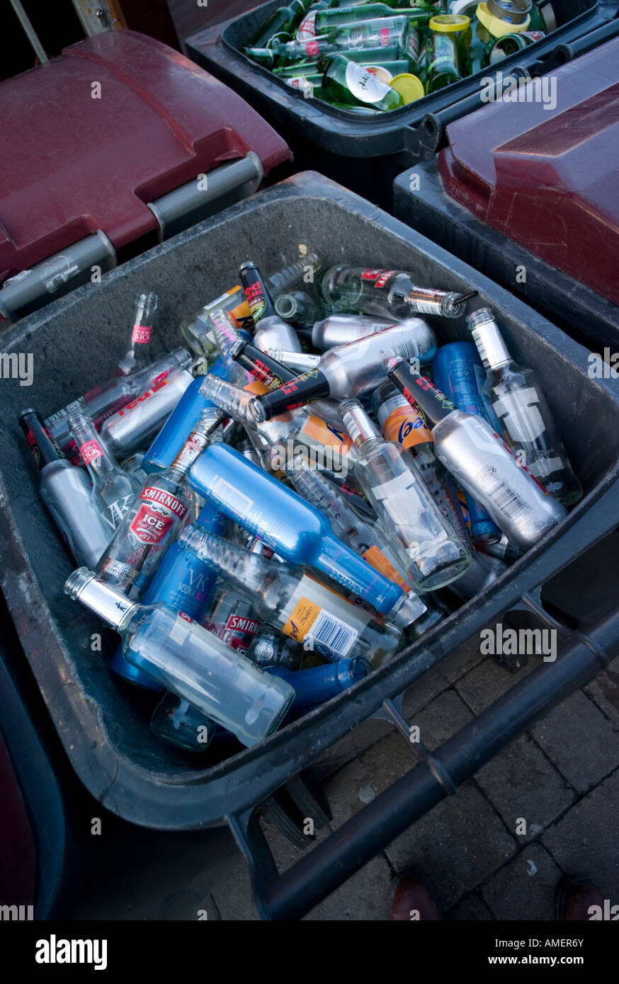 glass bottles of alcohol booze in skip outside pub waiting for ...
