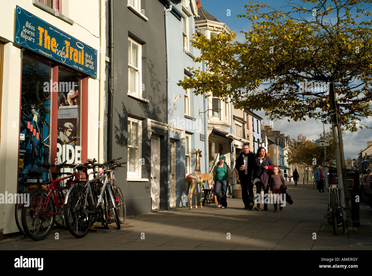 people family walking along Maengwyn Street Machynlleth Powys Mid Wales ...