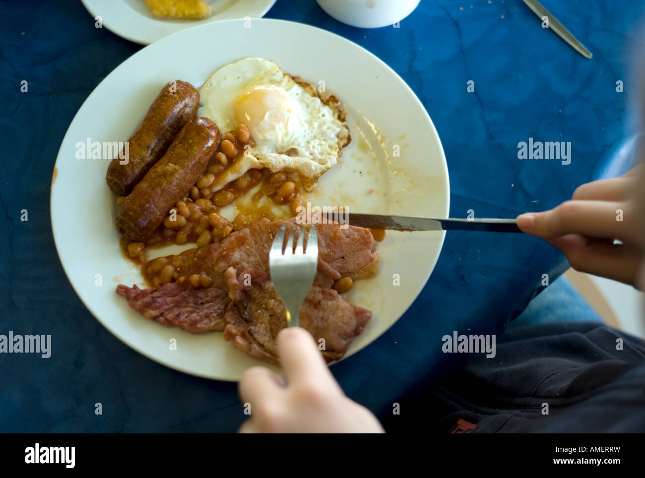 person eating Greasy fried full English breakfast bacon fried egg ...