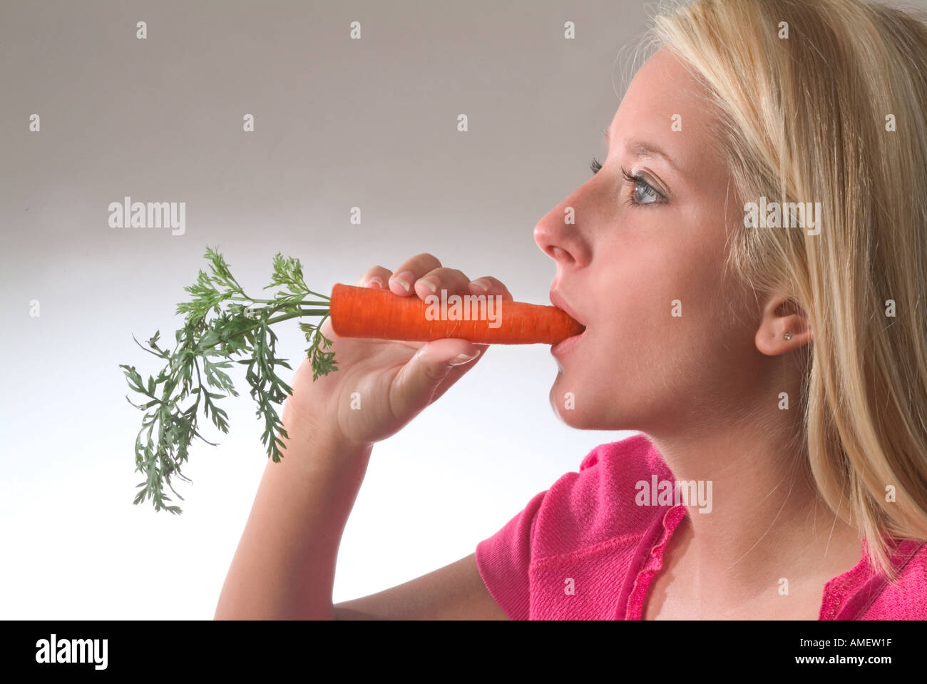 Teenager girl eating carrot hi-res stock photography and images - Alamy
