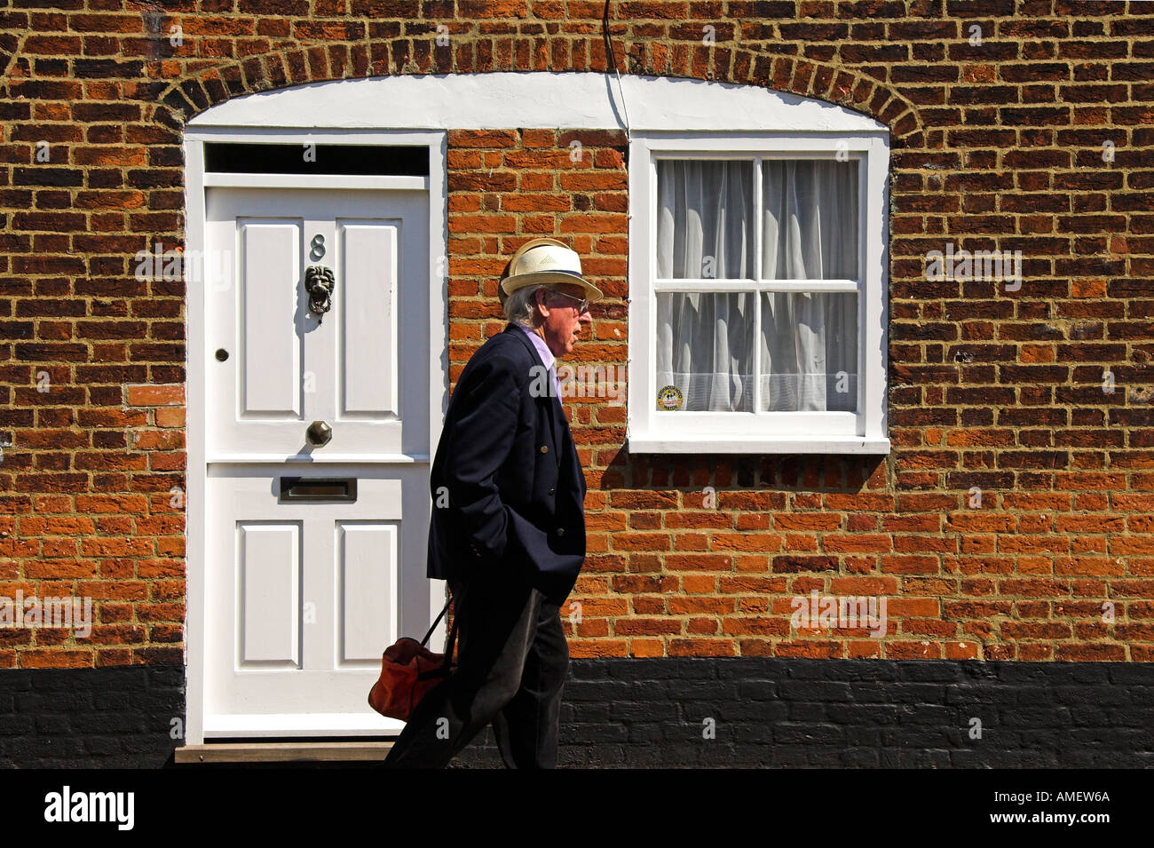 GOING HOME A man walking past a house Stock Photo - Alamy