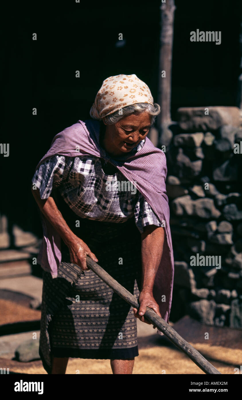 Farmer working outside a traditional tribal house in Kigwema village ...